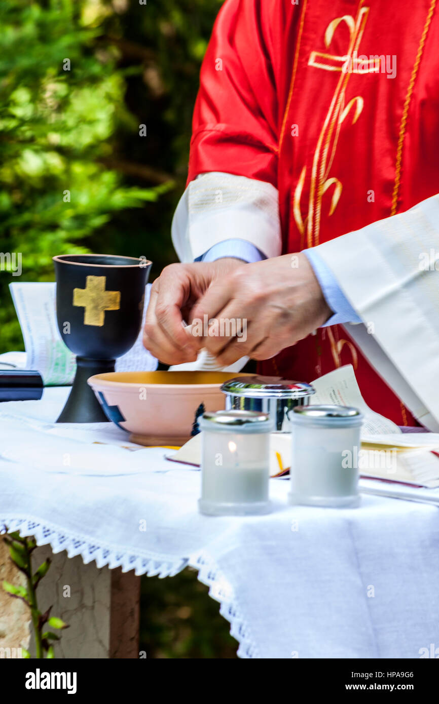 Priest preparing particles to give christian communion Stock Photo - Alamy