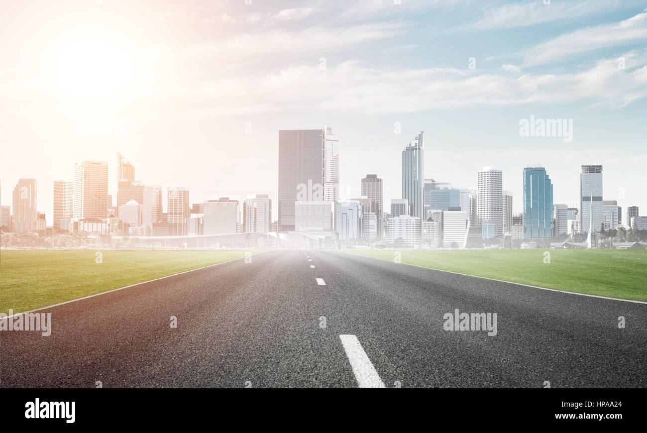 Natural landscape with asphalt road and modern city Stock Photo - Alamy