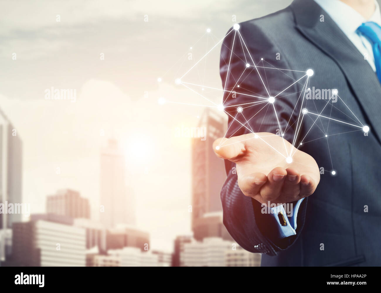 Businessman hand showing digital connection lines on city landscape ...