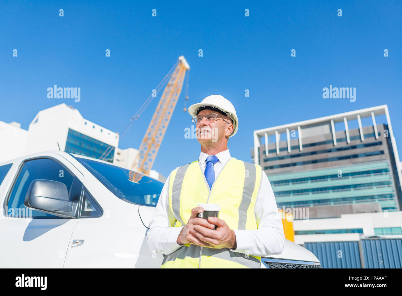 Senior engineer man in suit and helmet outdoor having coffee Stock ...