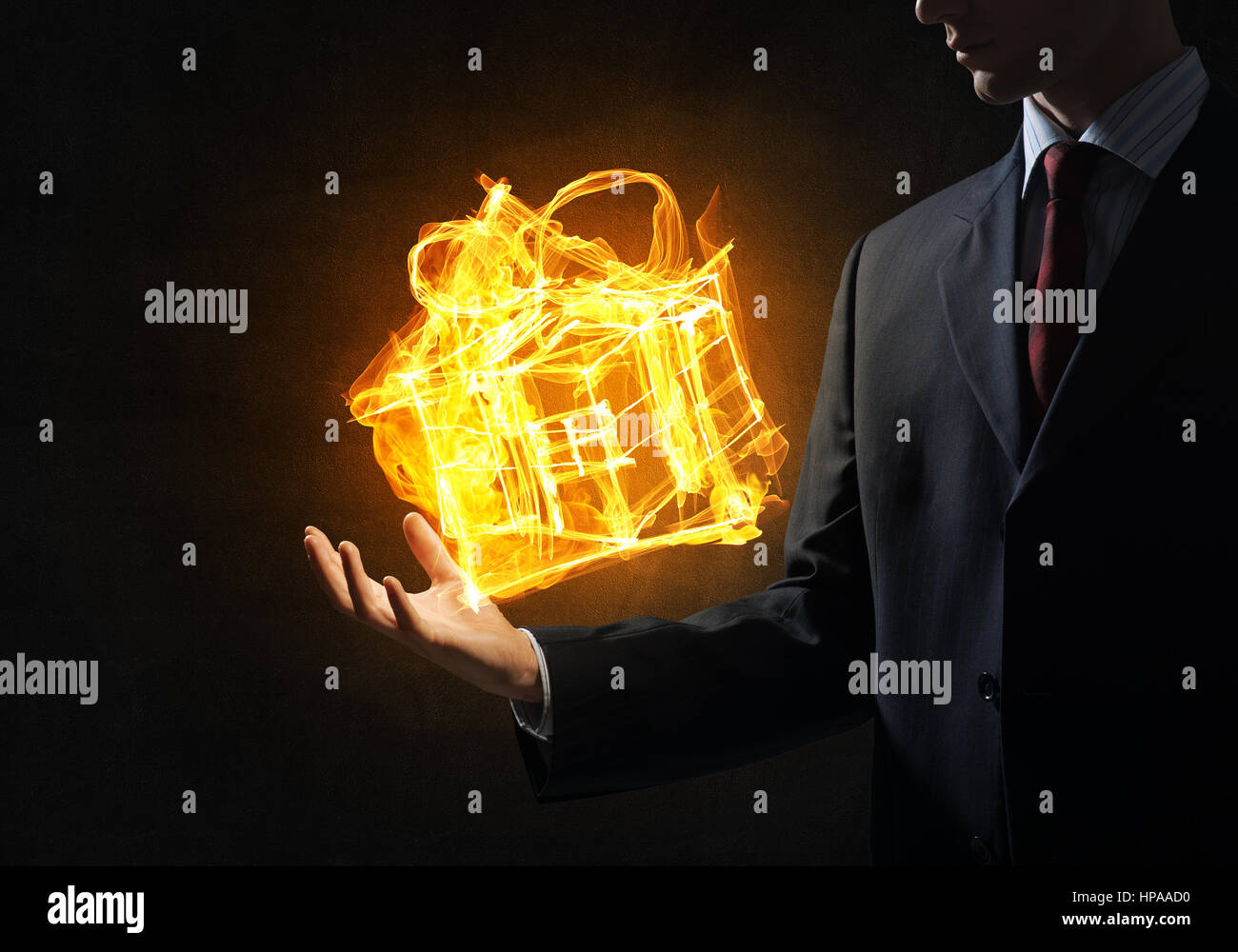 Glowing fire gift box icon in palm on dark background Stock Photo - Alamy