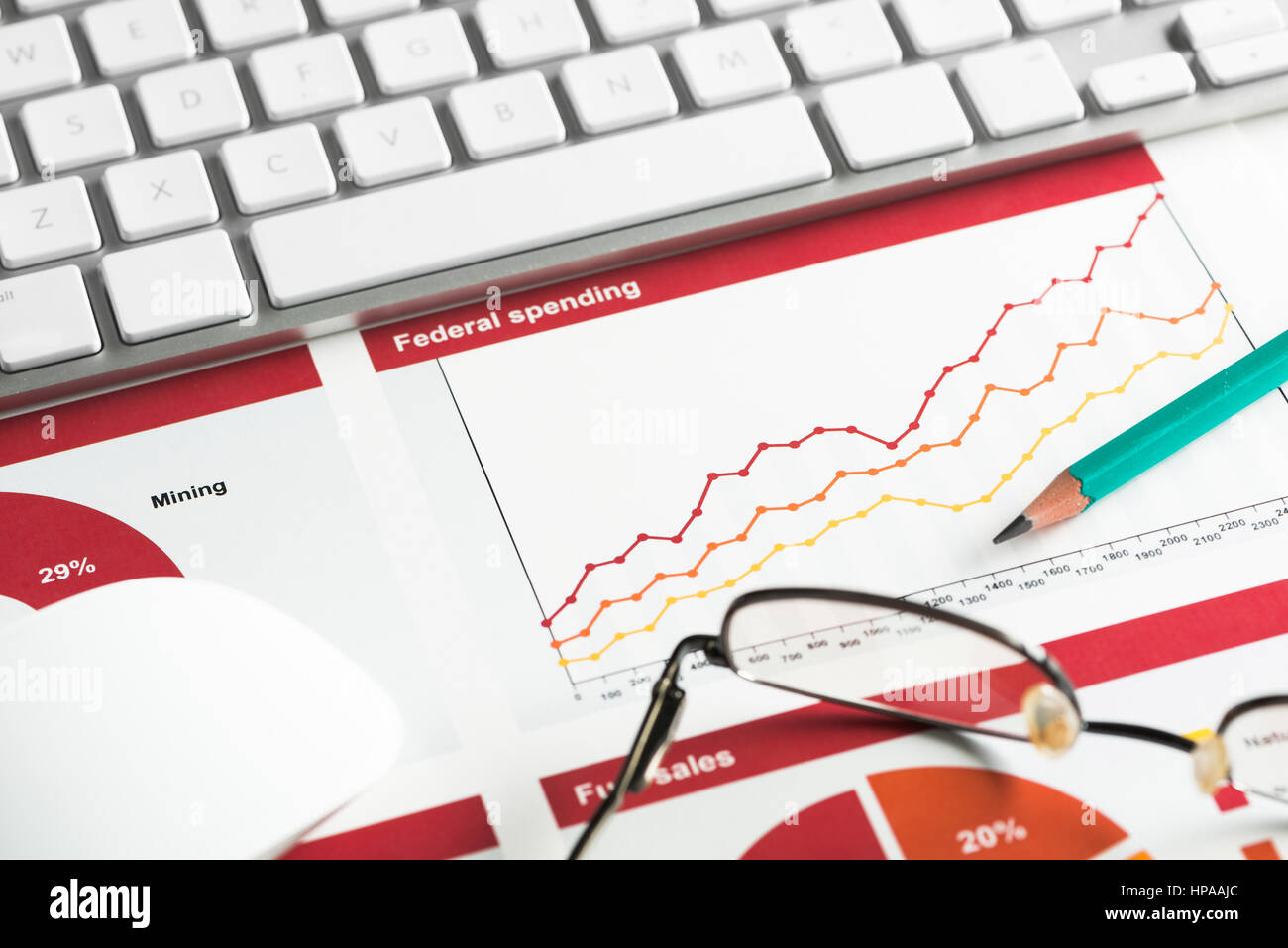 Business workplace with keyboard mouse and papers with graphs and ...