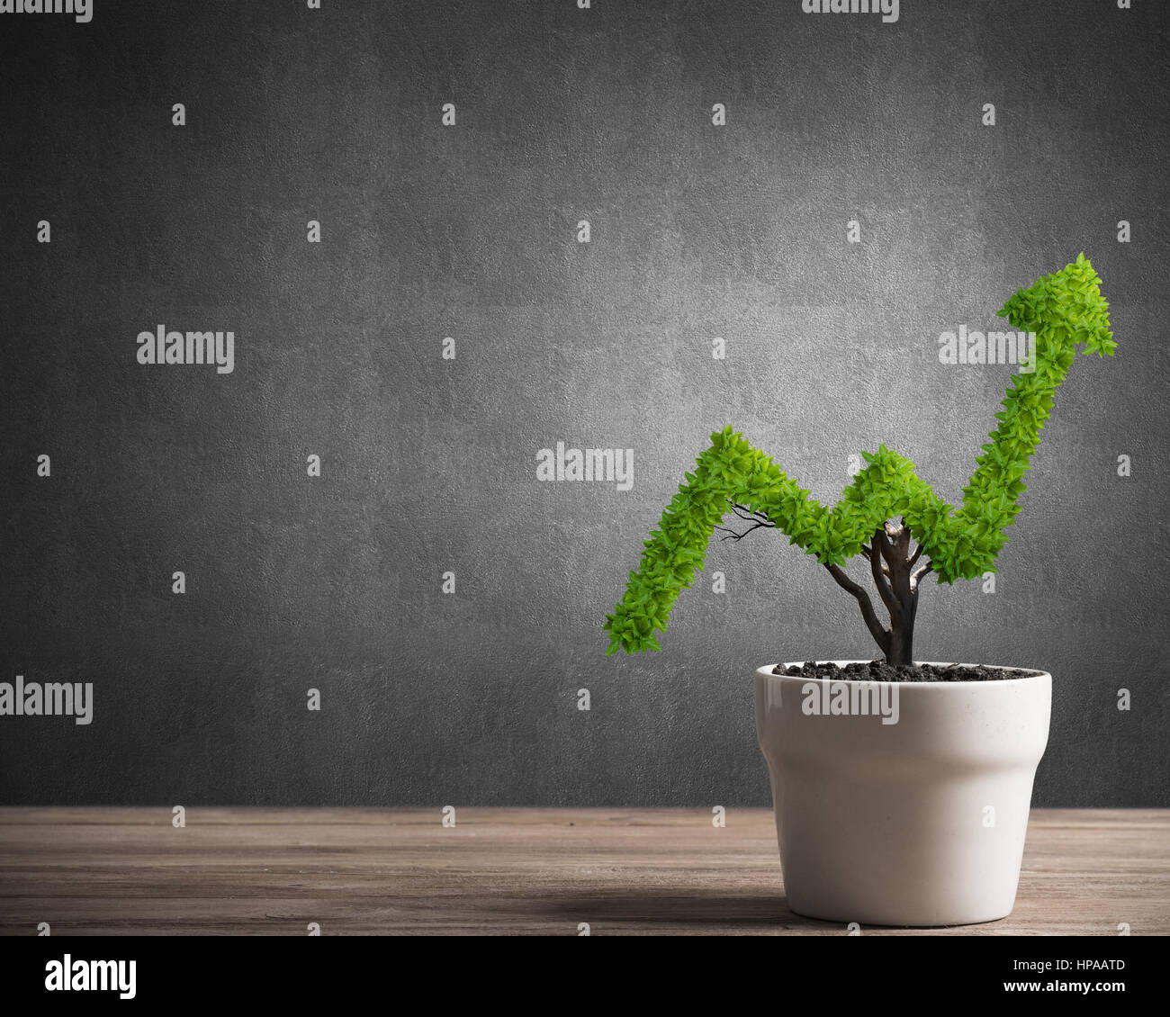 Small plant in pot shaped like growing graph Stock Photo - Alamy