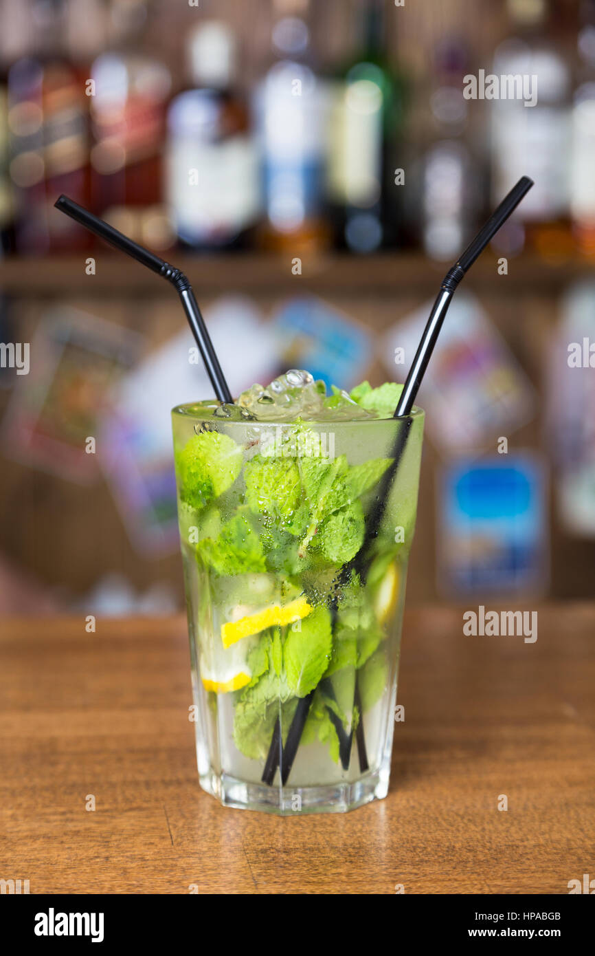 alcohol cocktail on wooden bar with bar background from glasses and ...