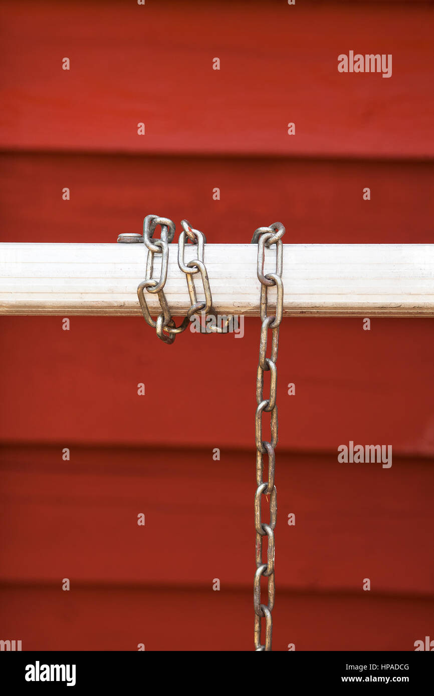 A metal chain wrapped around a bar Stock Photo - Alamy
