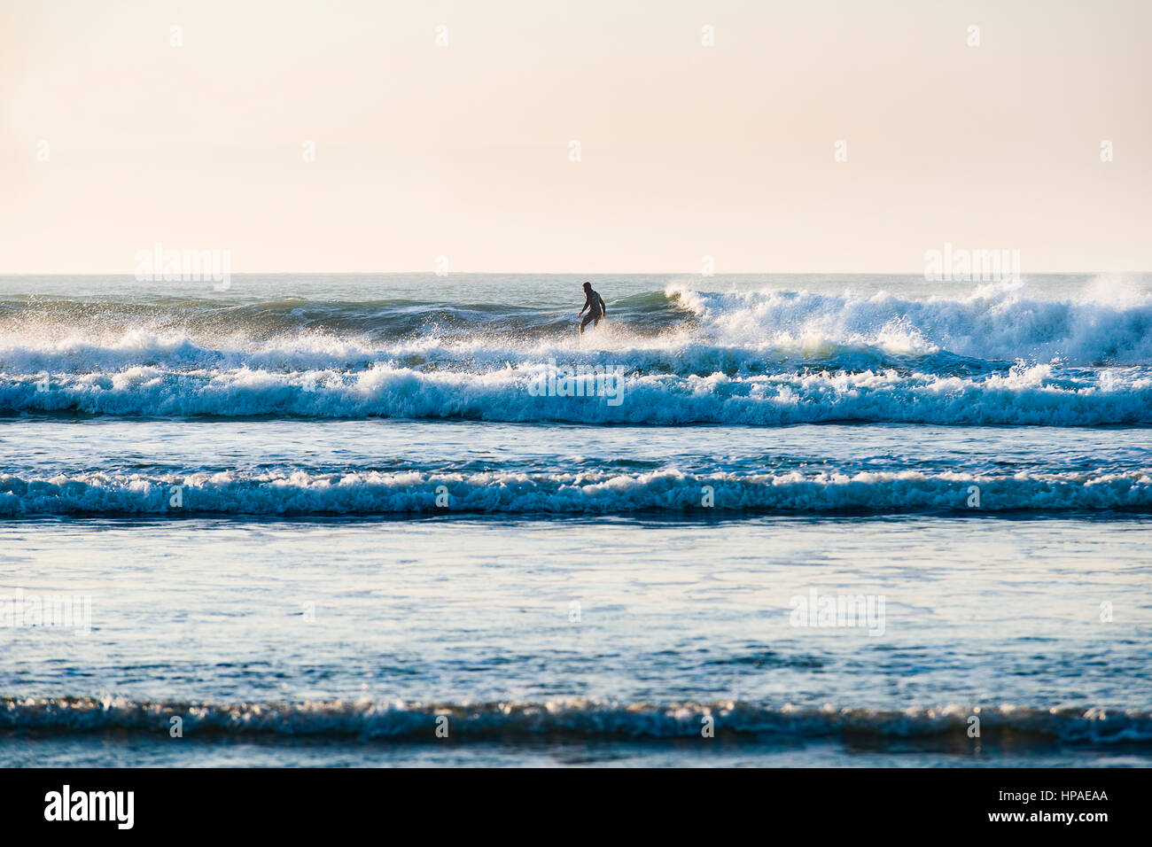 Surfer in action and catching some air after hitting the crest of a ...