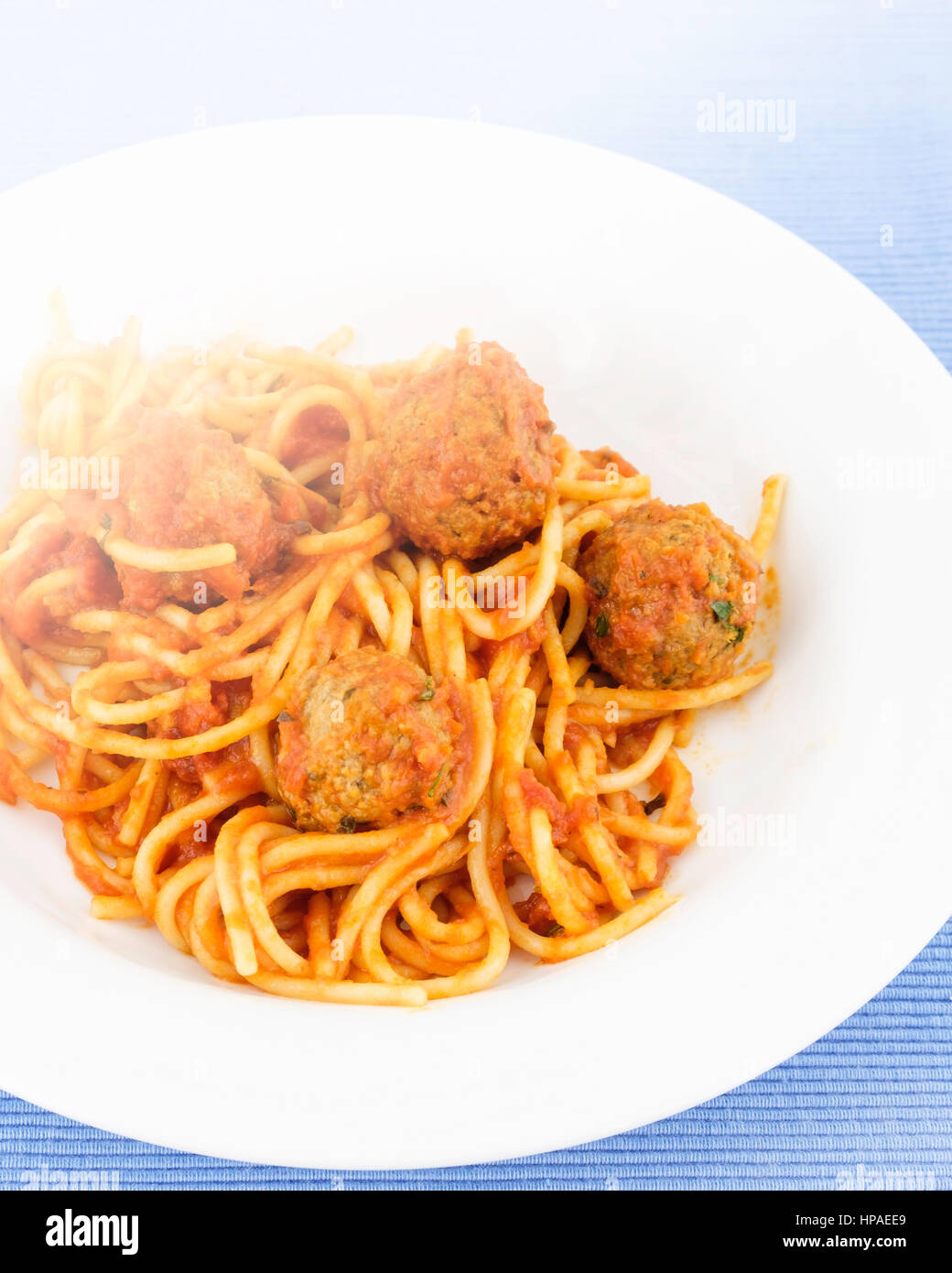 A plate of home cooked savory spaghetti and meatballs white plate on a ...