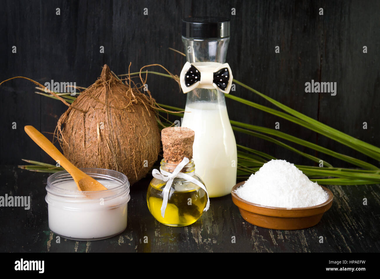Various coconut products set on black background Stock Photo - Alamy