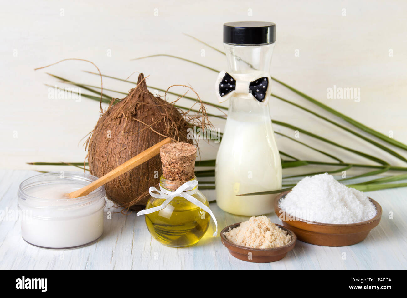Various coconut products set on white wooden background Stock Photo - Alamy