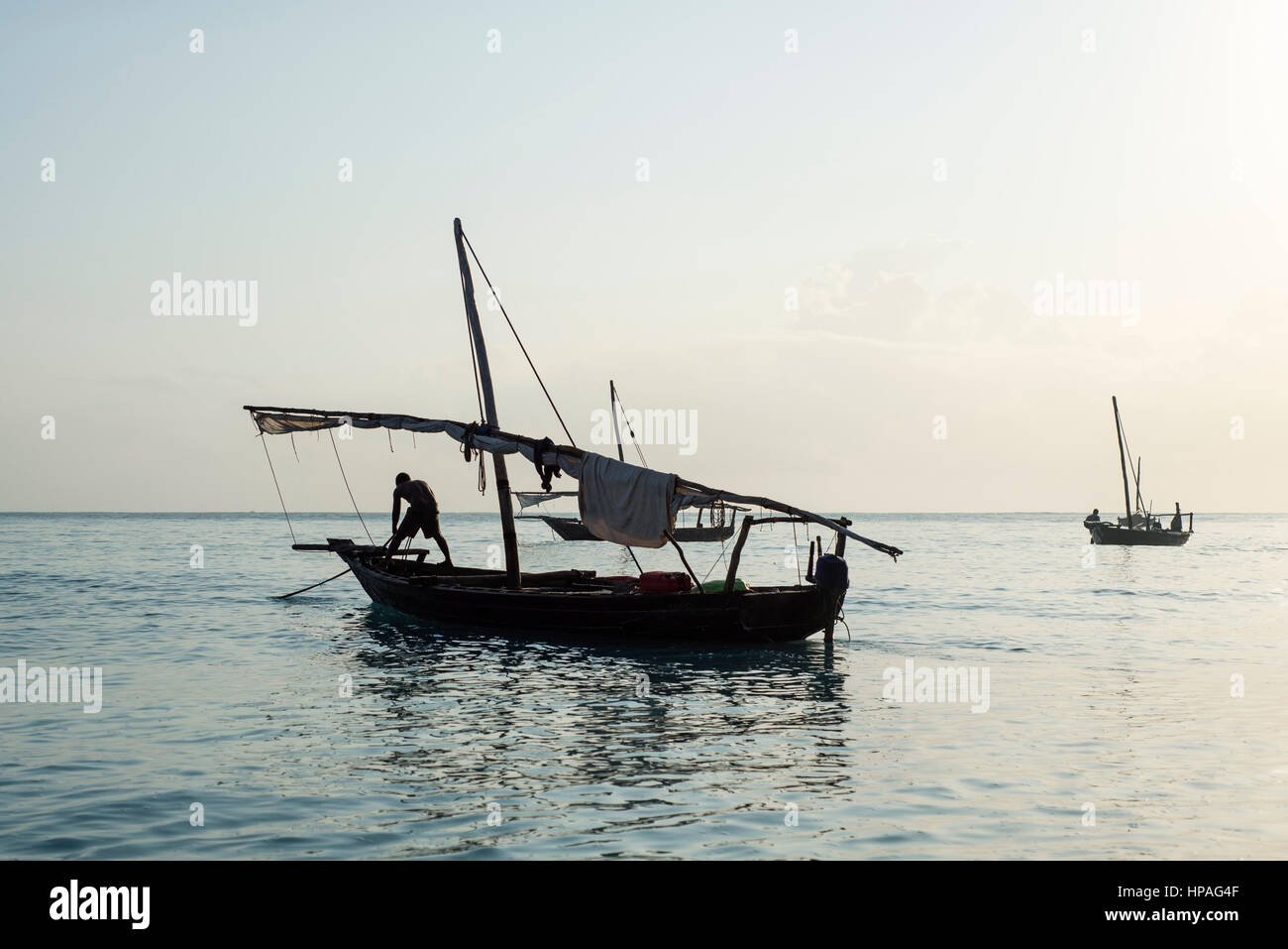 Fishermen moor the boat near the fish market in Nungwi village ...