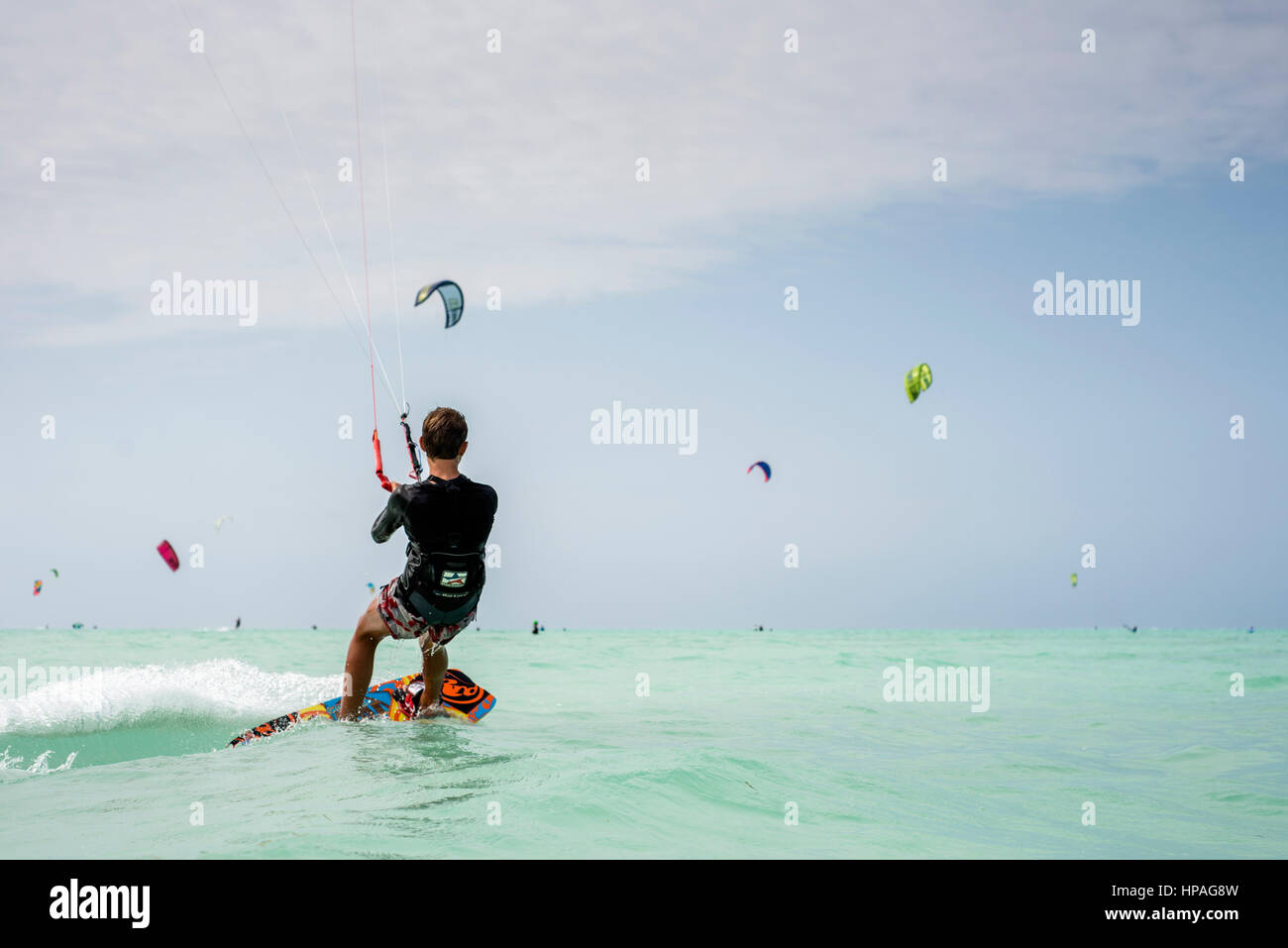 A boy flying kite on a beach of Paje, Zanzibar, Tanzania. Paje is a ...