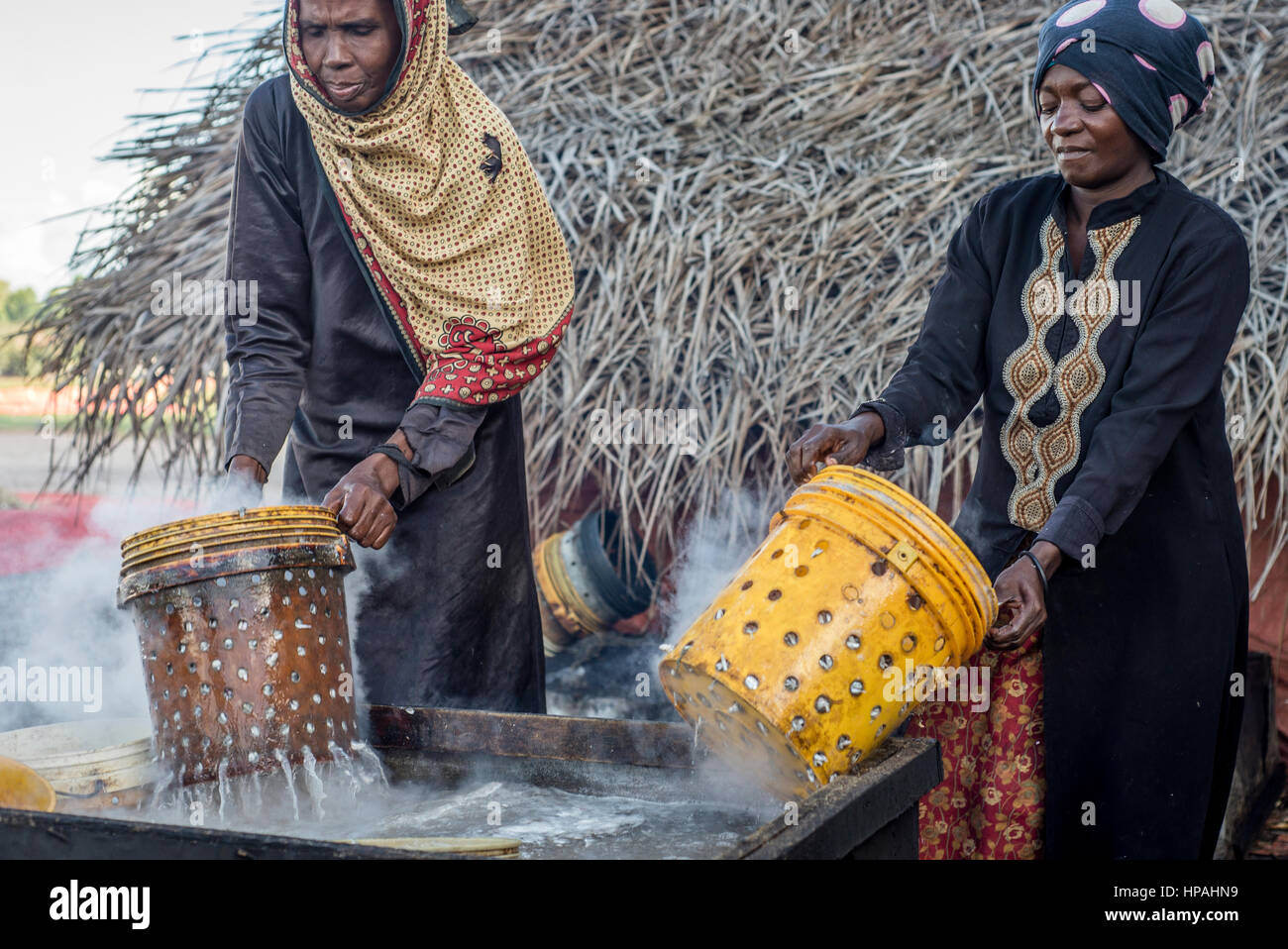 People prepare anchovies, locally called Dagaa, for drying at Mkokotoni ...