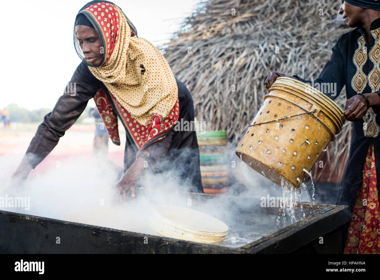 People prepare anchovies, locally called Dagaa, for drying at Mkokotoni ...