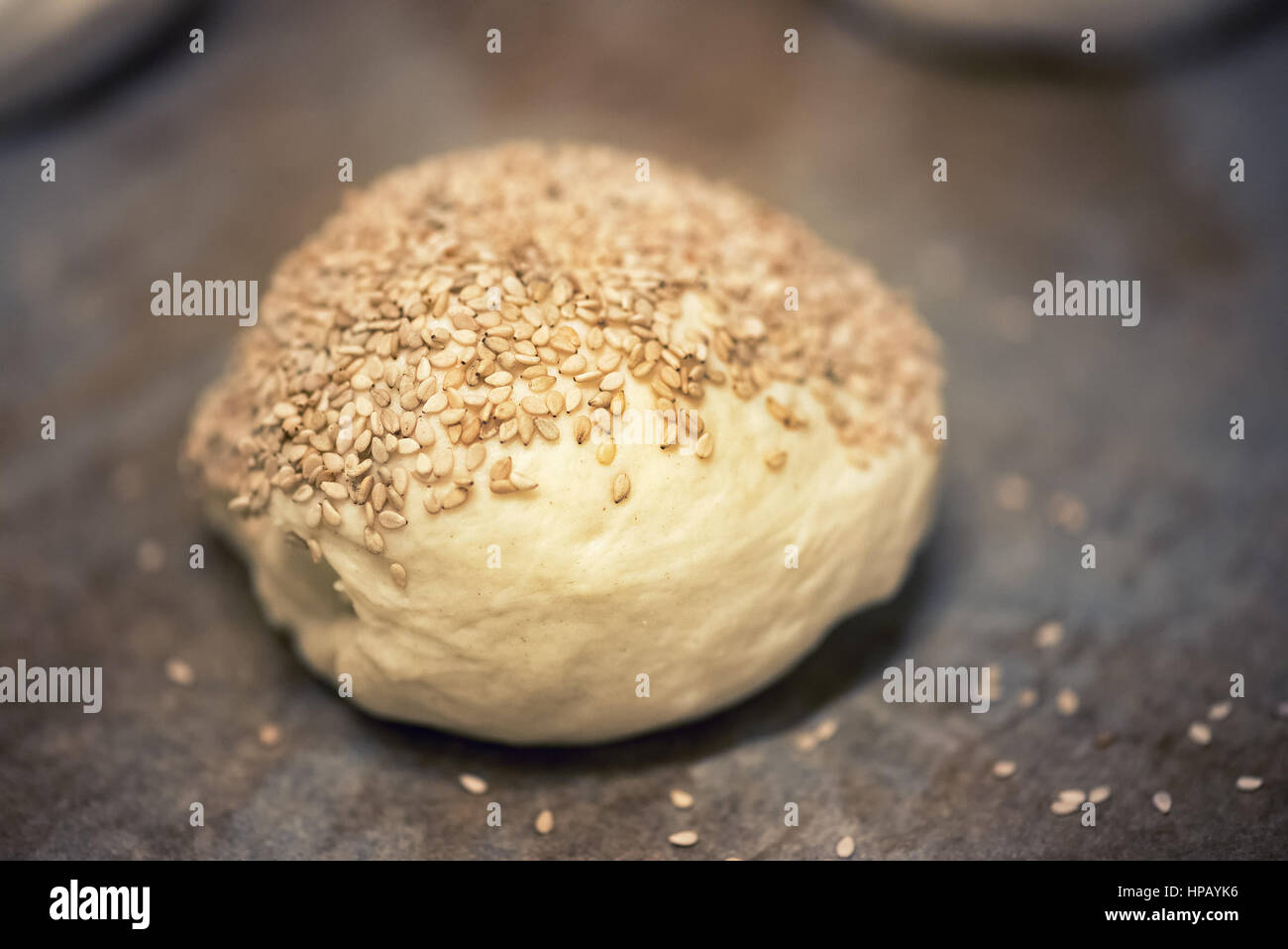 Close-up of single bun of white bread with sesame topping, selective ...