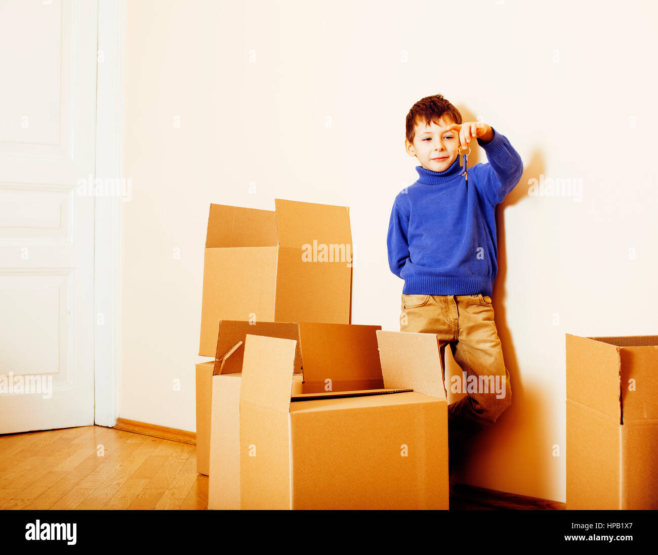 little cute boy in empty room, remoove to new house. home alone emong ...