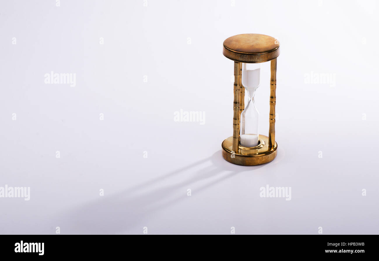 Vintage hourglass on gray background with long shadow Stock Photo - Alamy