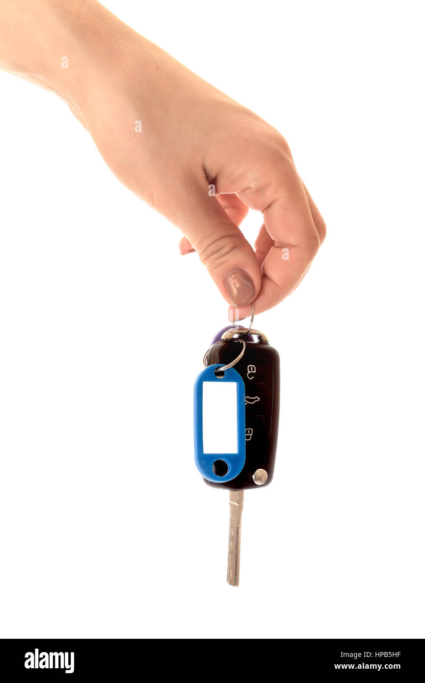 Close up of ignition key in hand isolated on white background. Car key ...