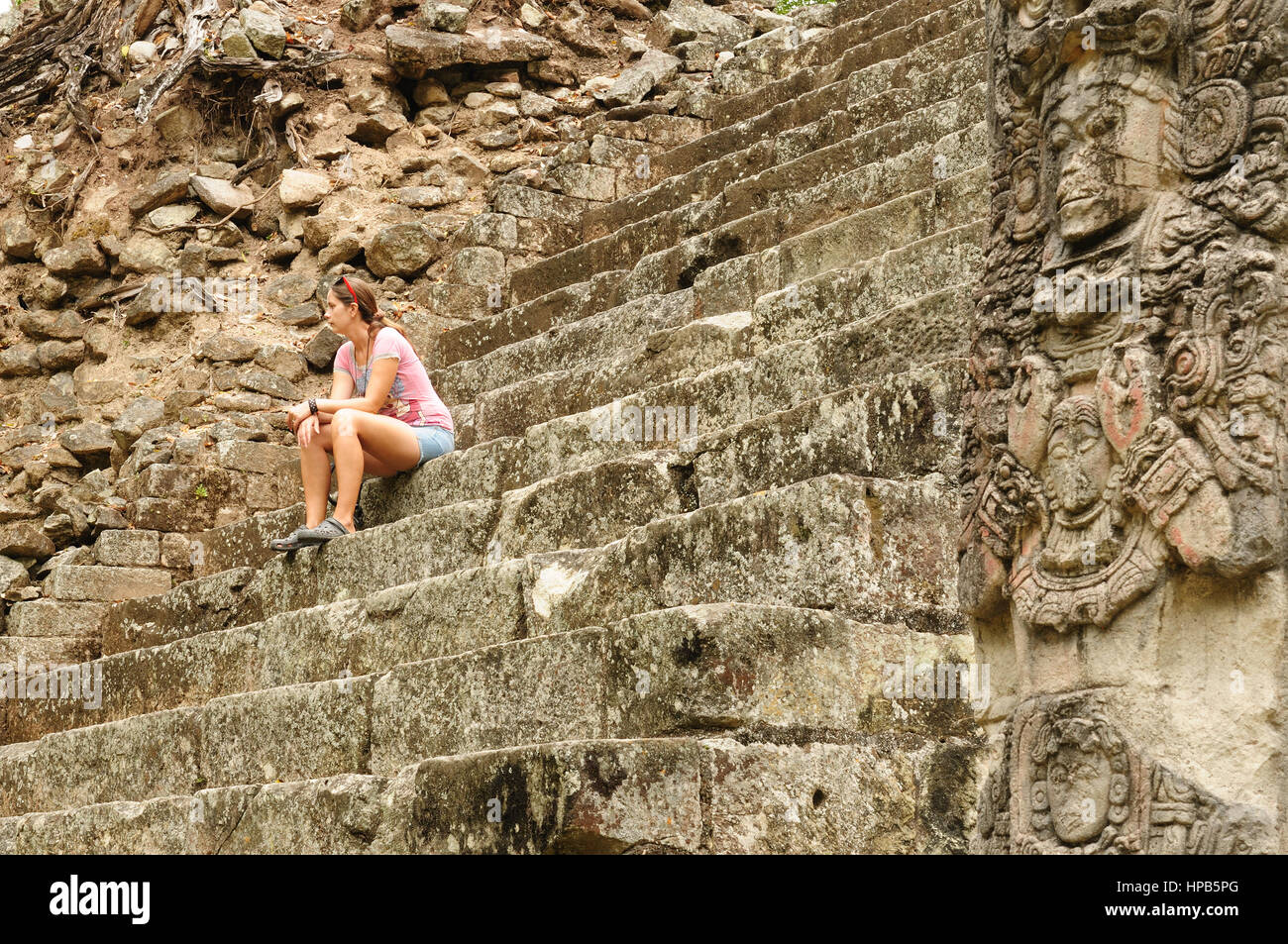 Honduras, Mayan city ruins in Copan. Tourist looks on the ruins from ...