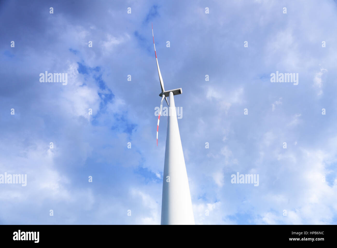 Close up of wind power plant. White power plant on blue sky background ...