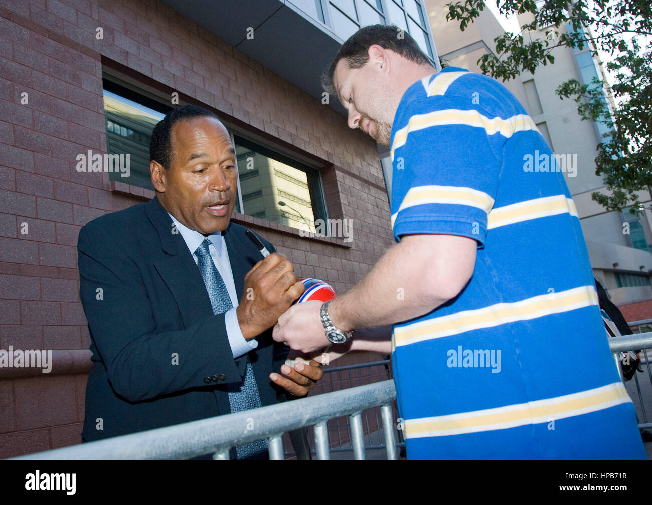 O.J. Simpson signs an autograph for a fan at the Clark County Regional ...
