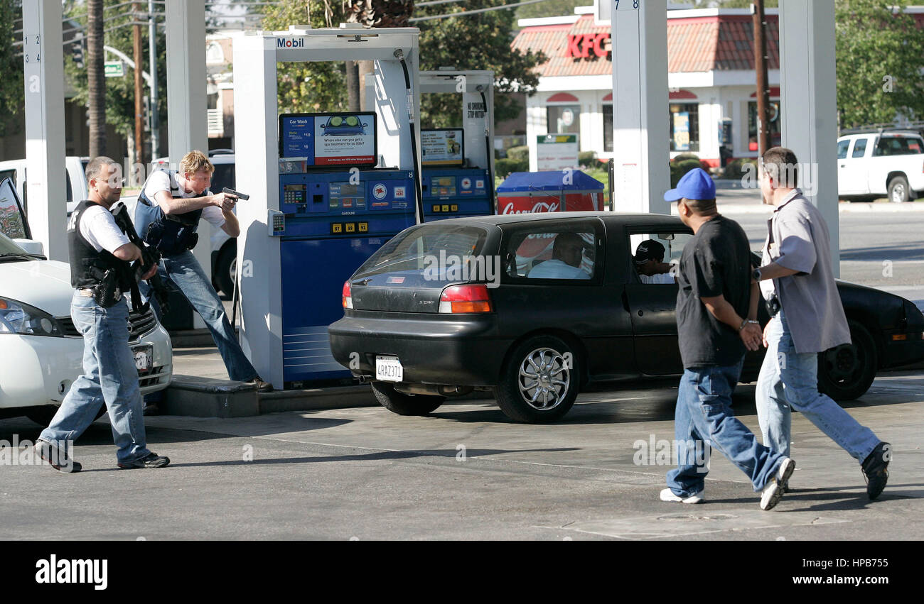 FBI agents arrest a group of men at the Mobil gas station on Madison ...