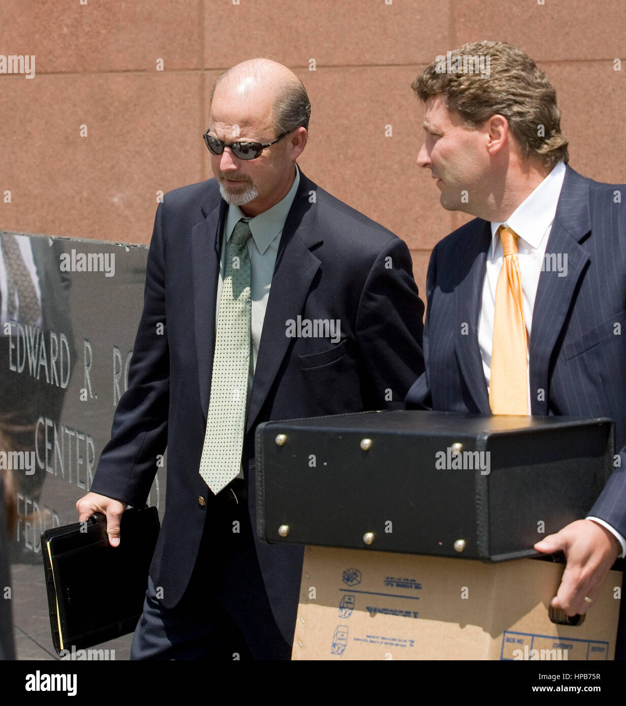 Attorney Chad Hummel, right, talks to Mark Arneson after leaving the ...