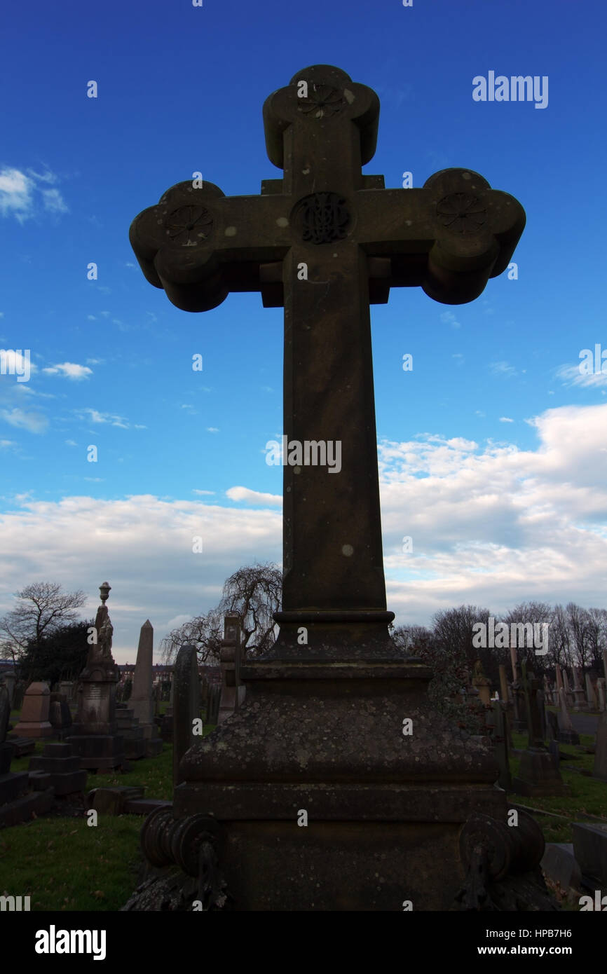Graveyard cross in silhouette against a blue sky Stock Photo - Alamy