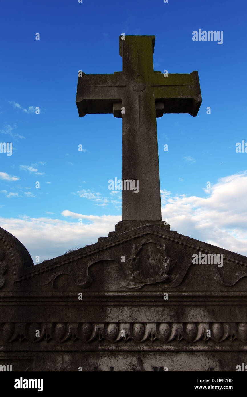 Graveyard cross in silhouette against a blue sky Stock Photo - Alamy