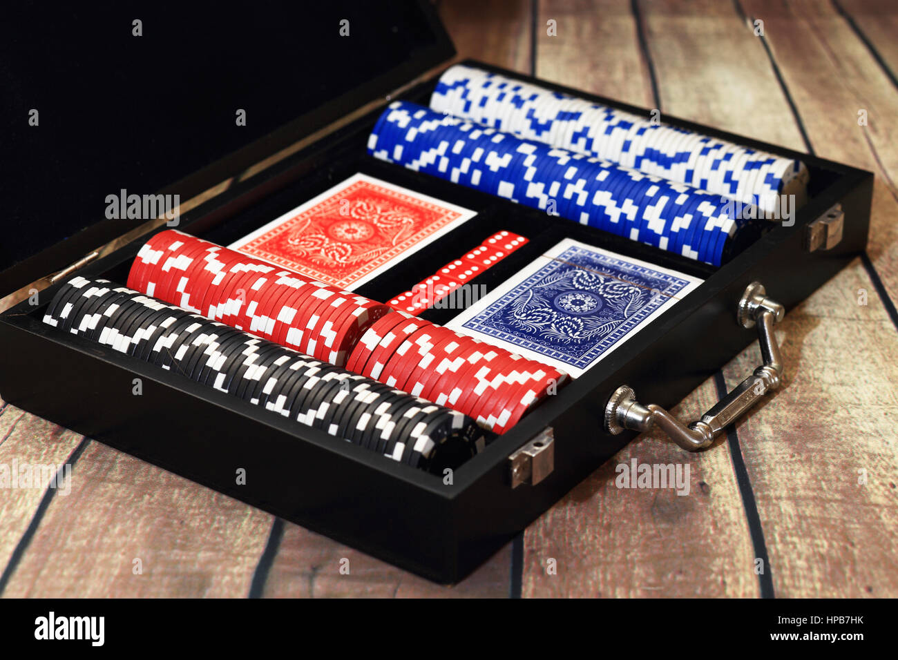 Chips cards and dice in black suitcase close up. Poker set in suitcase ...