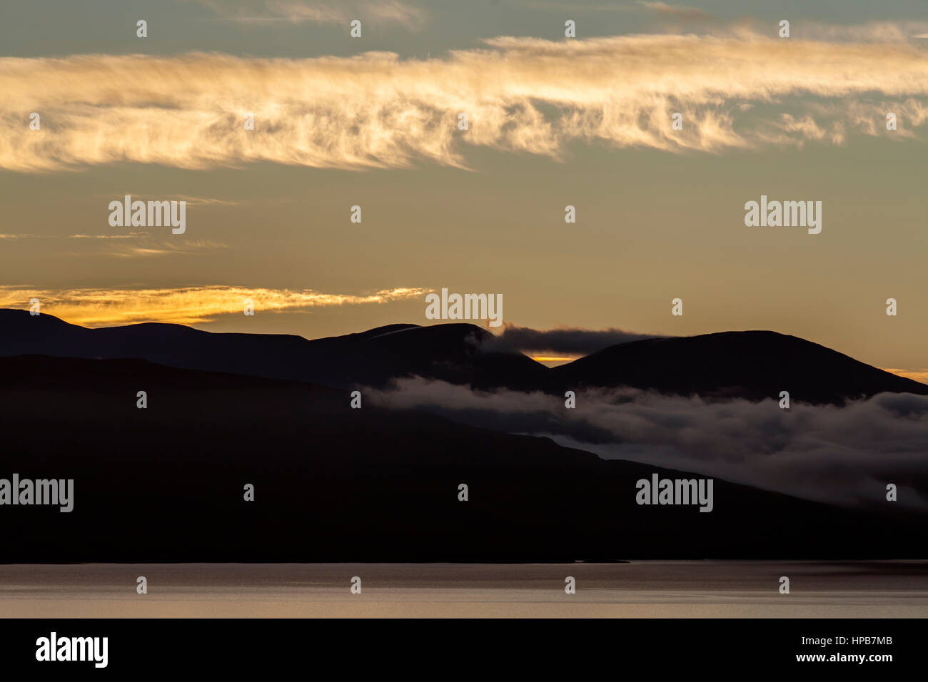 Sunset, nightfall in the Nordic mountains. Lake this side and mountain ...