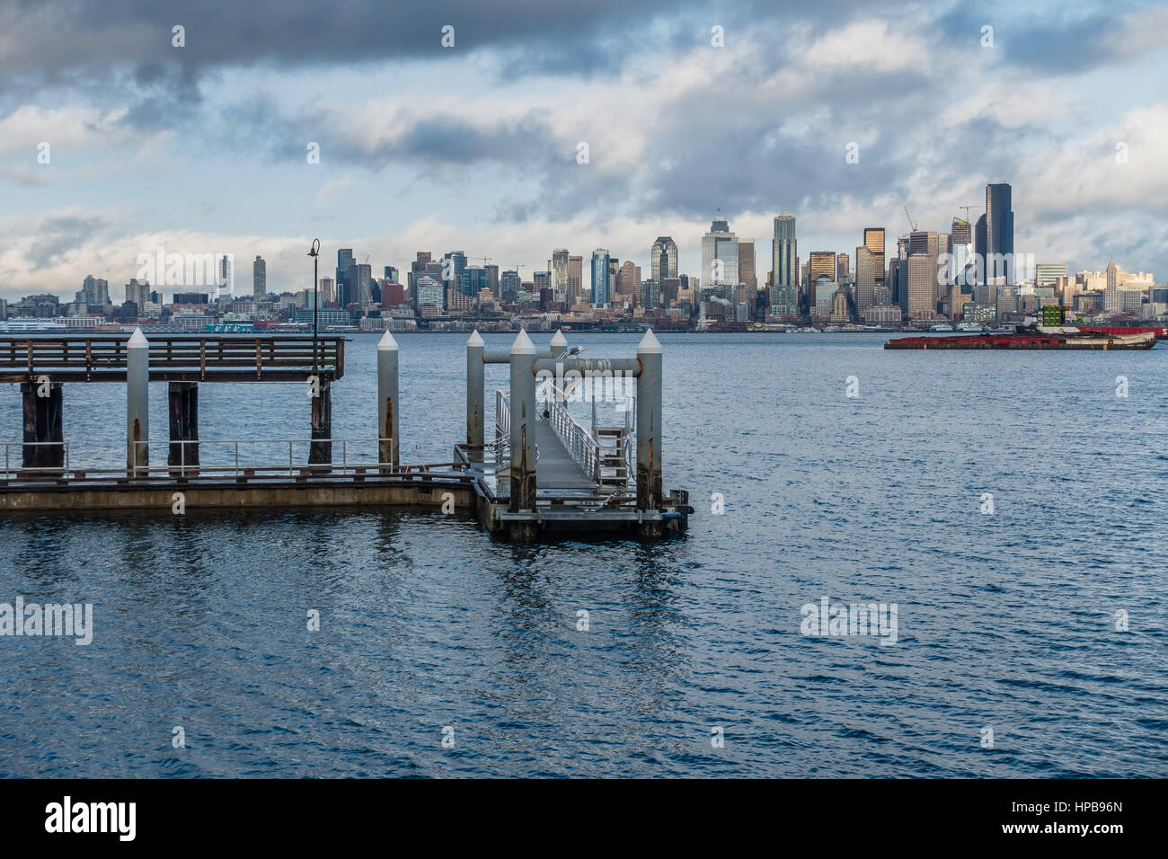 A view of a pier with the Seattle skyline across the water Stock Photo ...