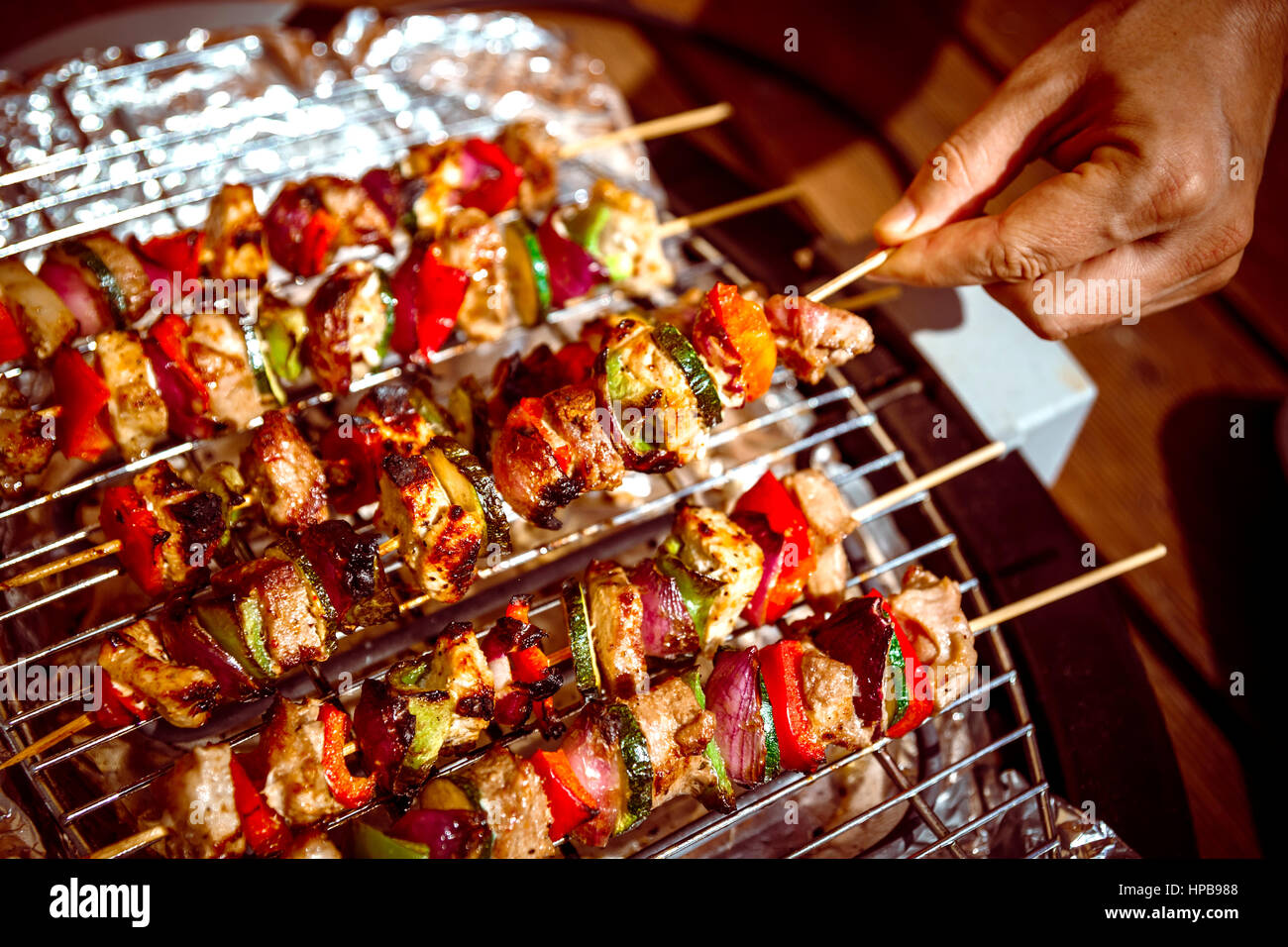Spit Roast Beef Kebabs On The Hot Flaming BBQ Grill Close-up.Hand of ...