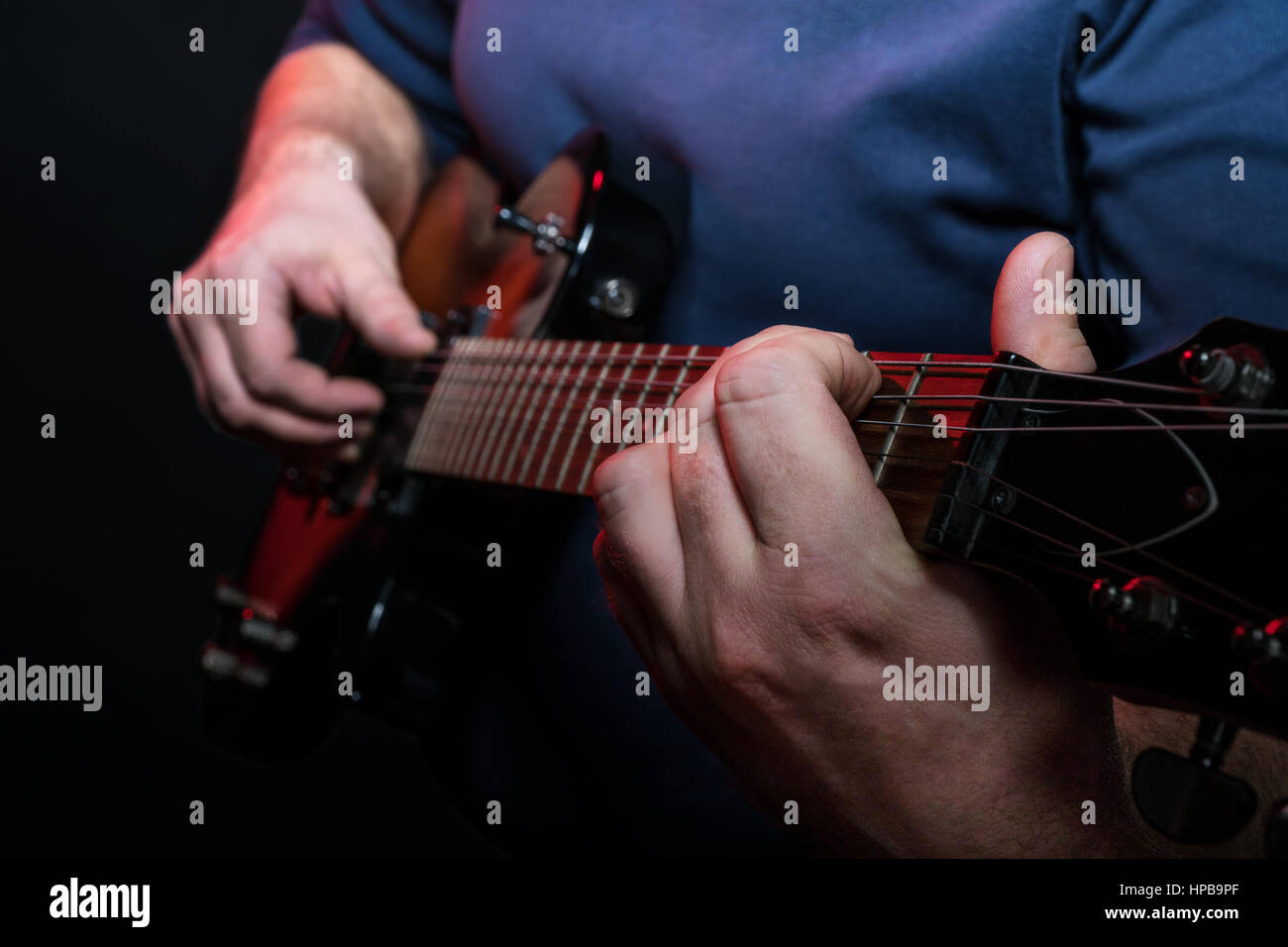 Guitarist playing guitar close up Stock Photo - Alamy