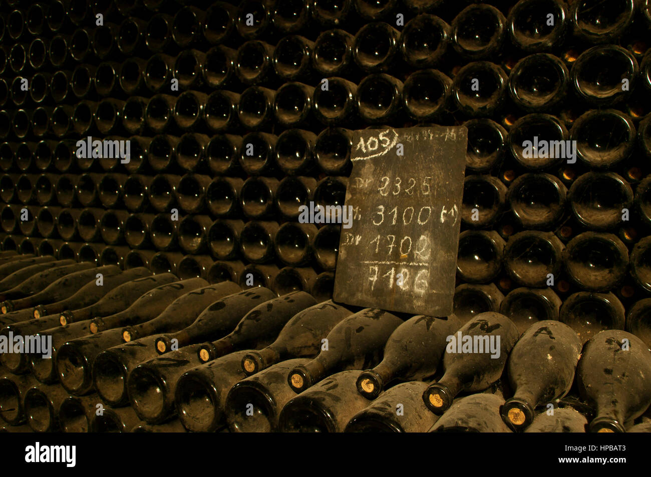 Wine bottles in a wine cellar Stock Photo - Alamy