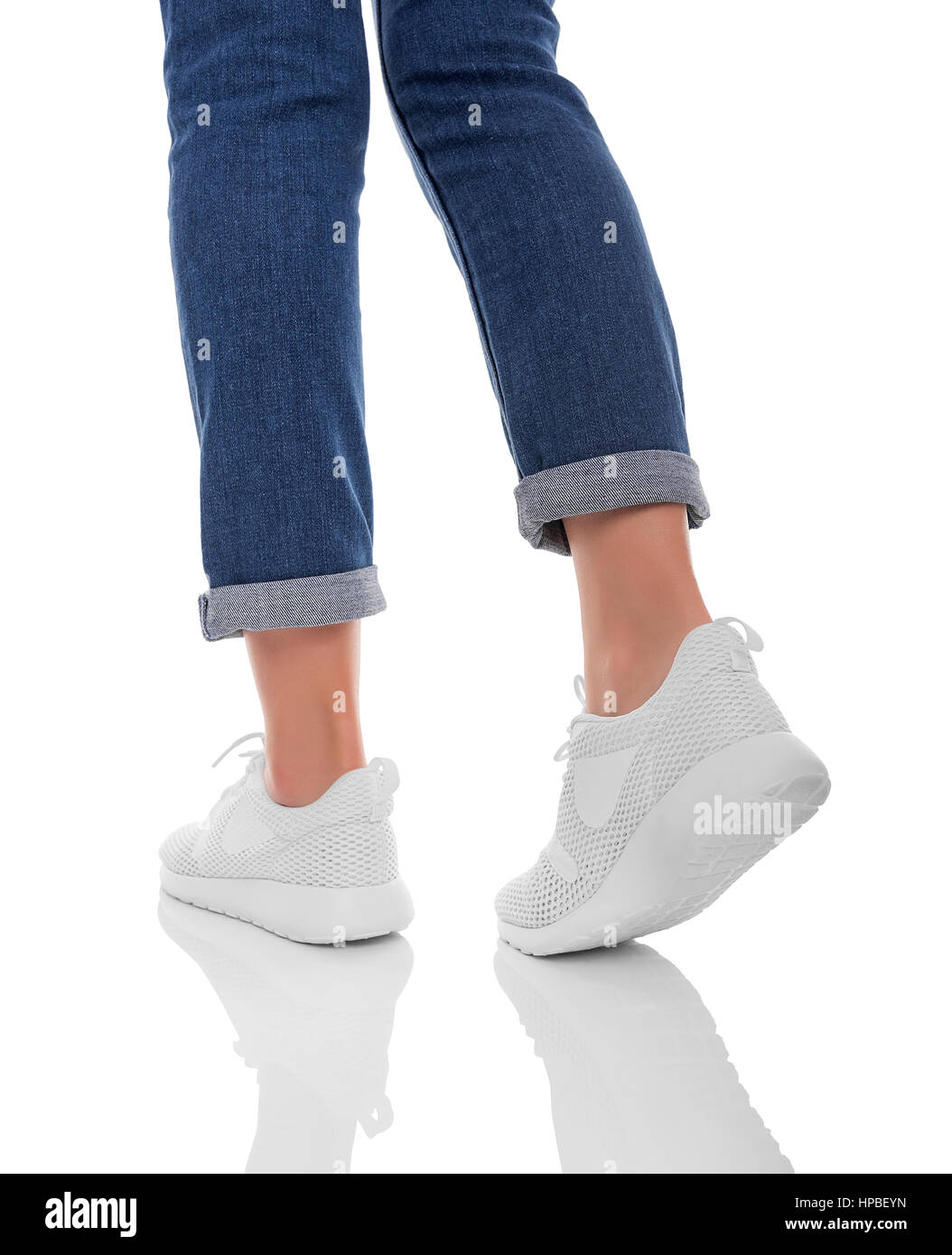 Female feet in sneakers. Do step. Isolated on white background Stock ...