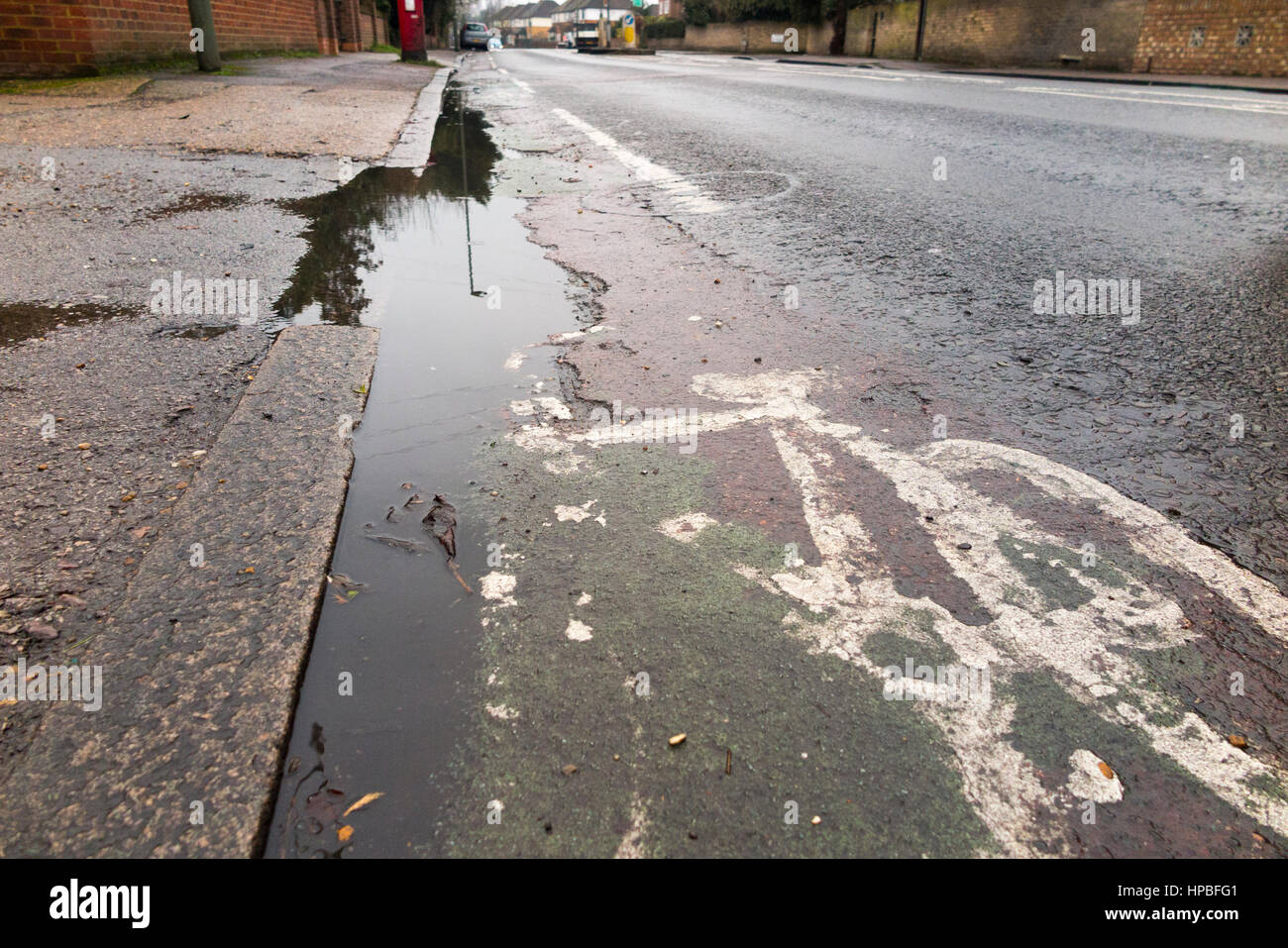 Poor quality broken bicycle / bike / cycle lane / lanes with a cracked ...
