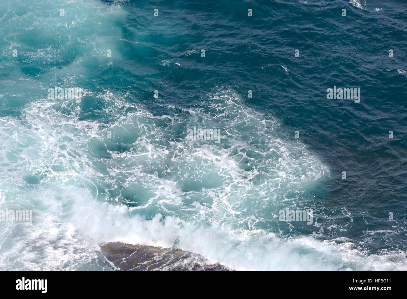 Waves hitting shore Stock Photo - Alamy