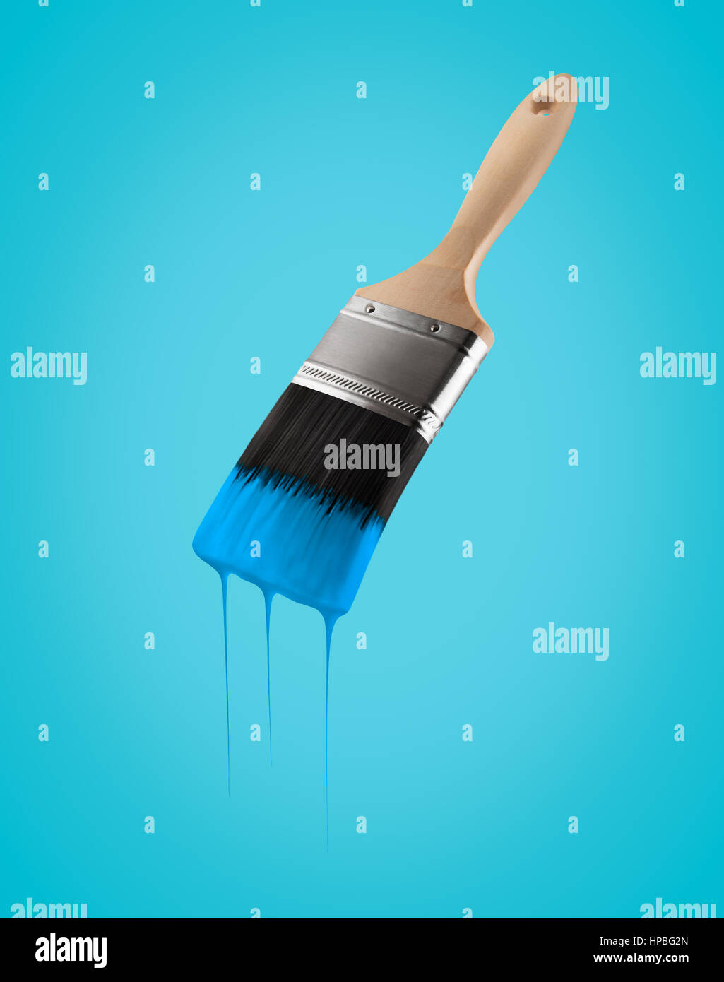 Paintbrush loaded with blue sky color dripping off the bristles, on ...