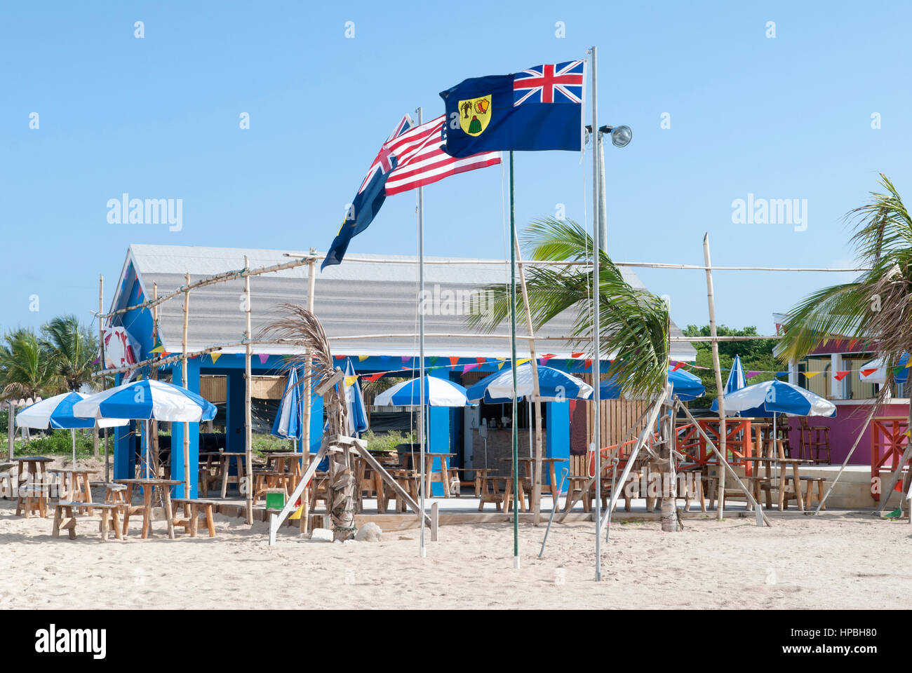 The flag of Turks & Caicos next to the wooden restaurant on Grand Turk ...