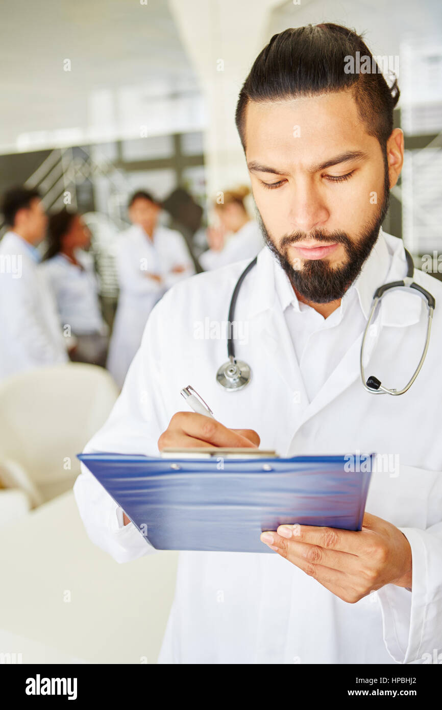Man as doctor taking notes in clipboard for control Stock Photo - Alamy