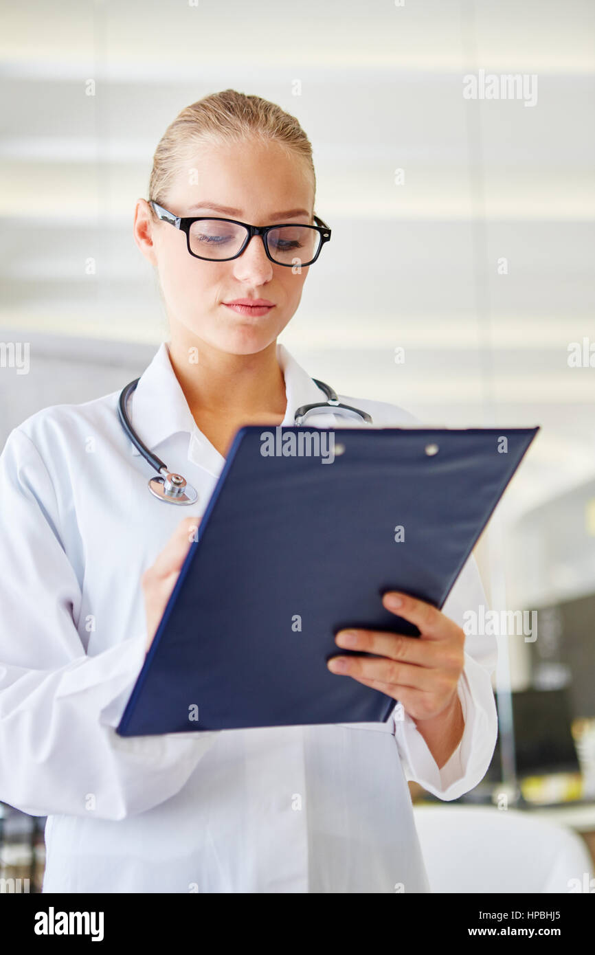 Young woman as doctor with checklist patient record for control Stock ...