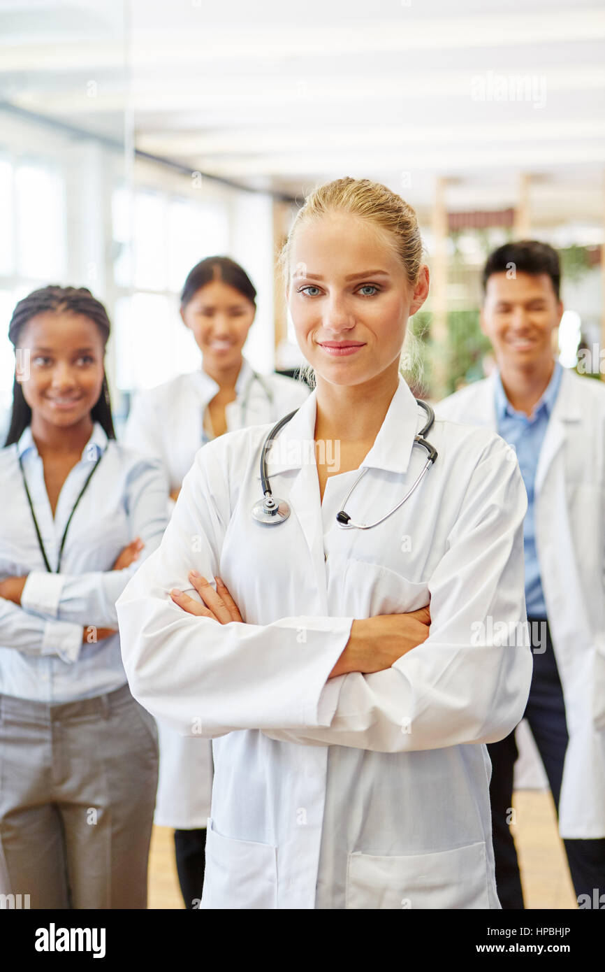 Self confident woman as doctor with team showing leadership Stock Photo ...