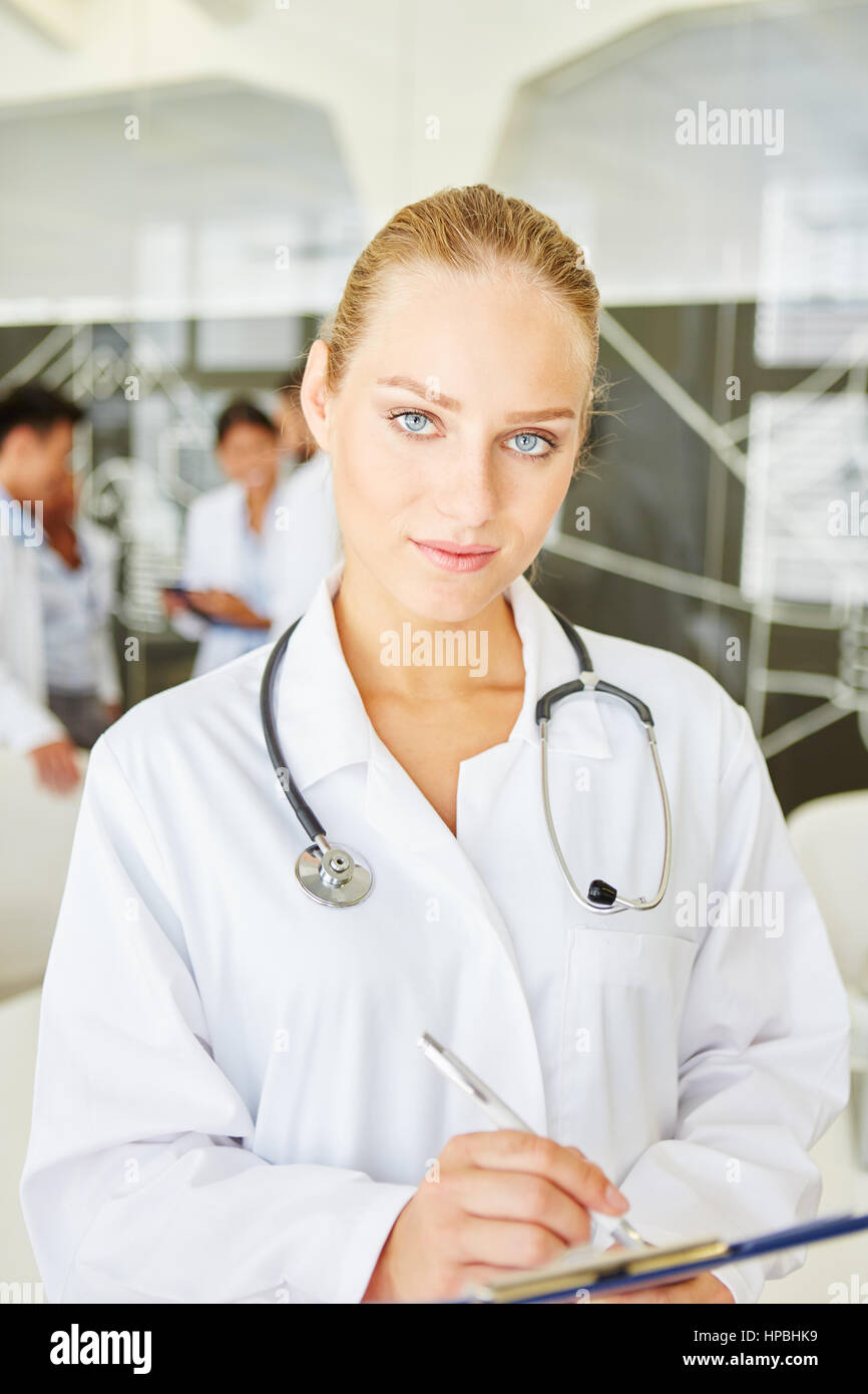 Competent woman as doctor with checklist for medical records Stock ...