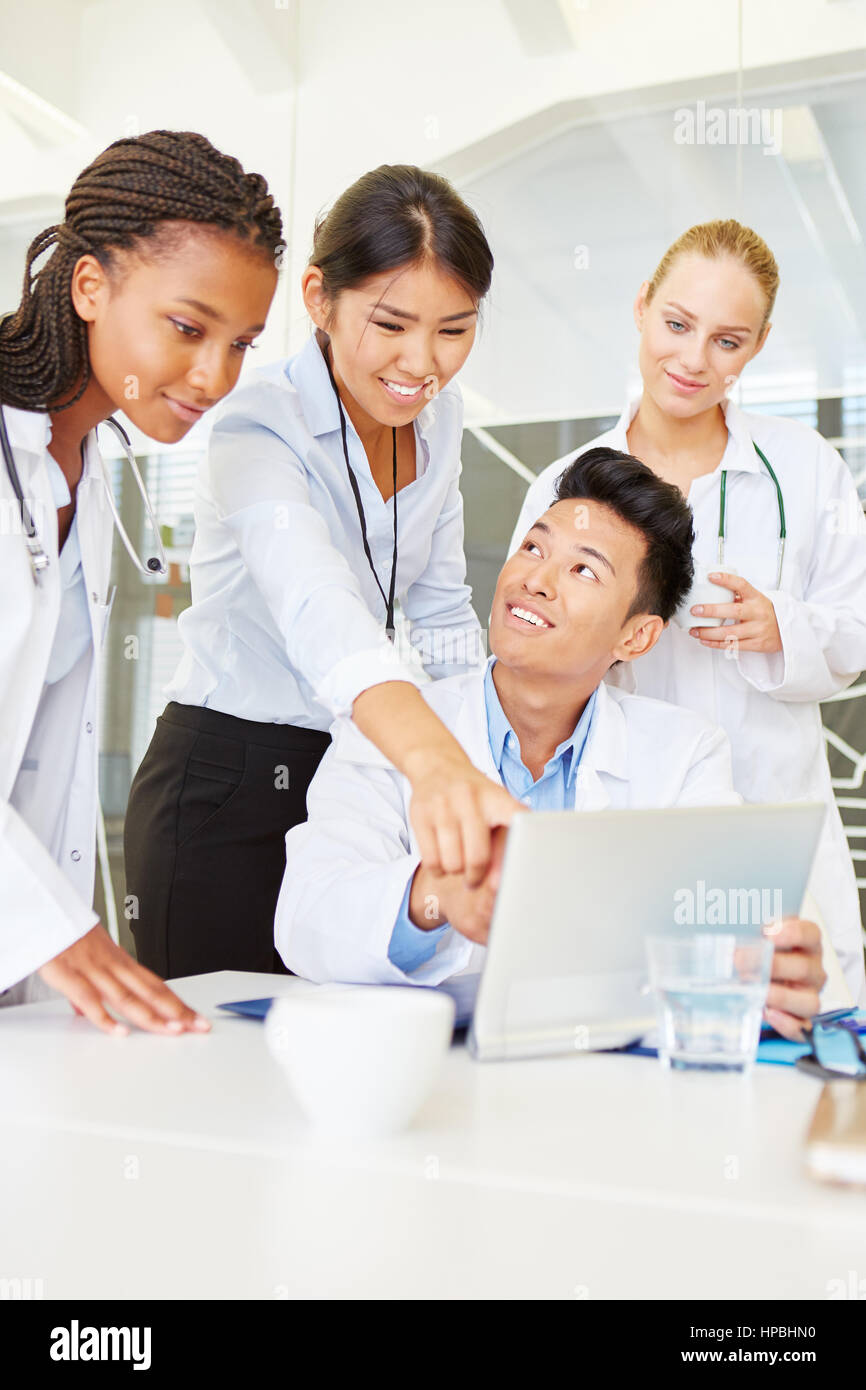 Interracial team of doctors learning together in training Stock Photo ...