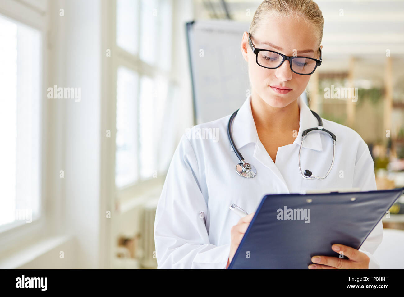Doctor with clipboard controls patient record in hospital Stock Photo ...