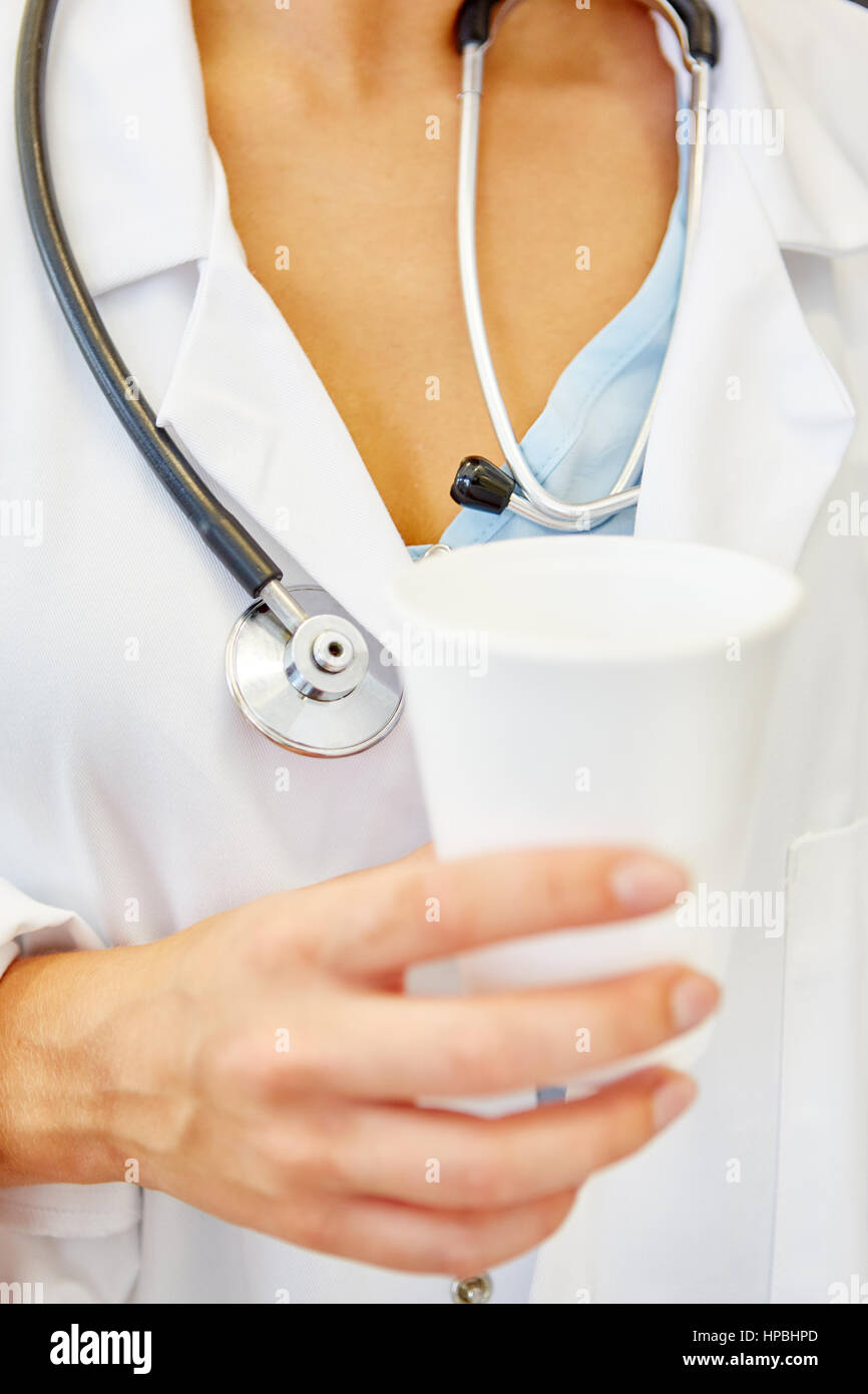 Doctor as cardiologist with stethoscope as tool for making diagnostics ...