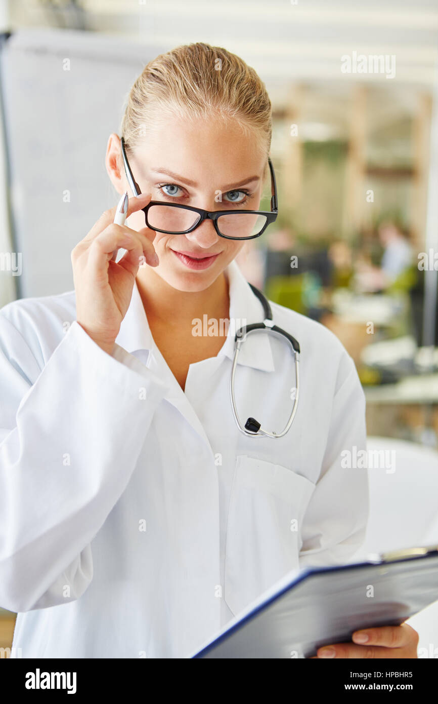 Young woman as competent doctor with checklist in hospital Stock Photo ...