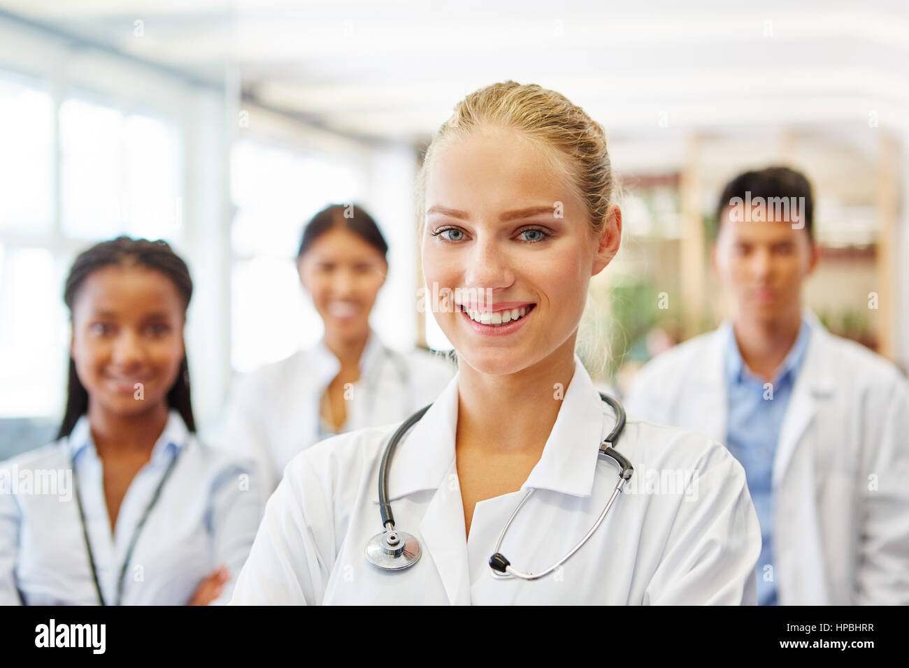 Woman as successful and friendly doctor with hospital staff Stock Photo ...