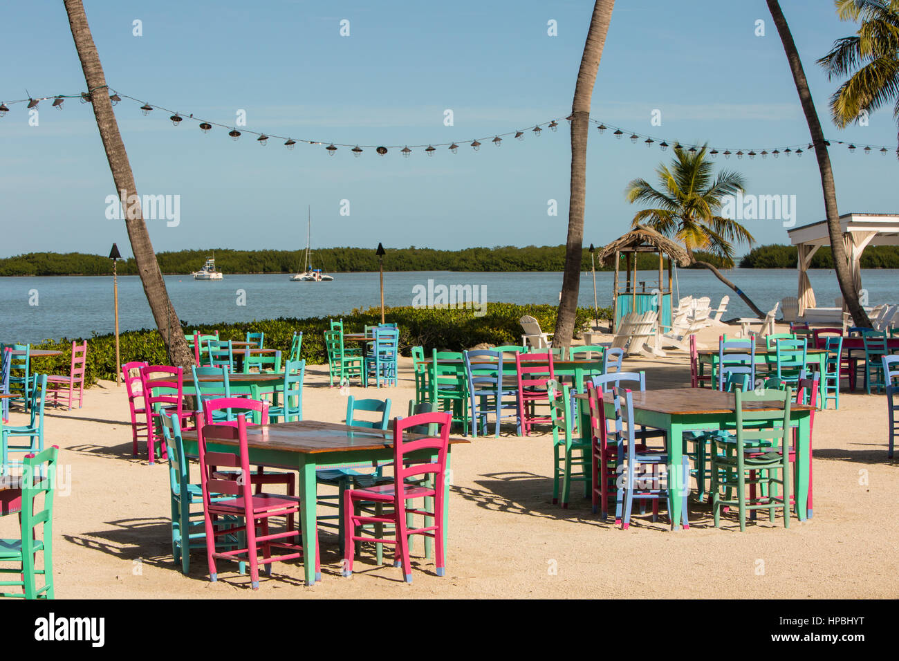Colorful tables and chairs on beach Stock Photo - Alamy