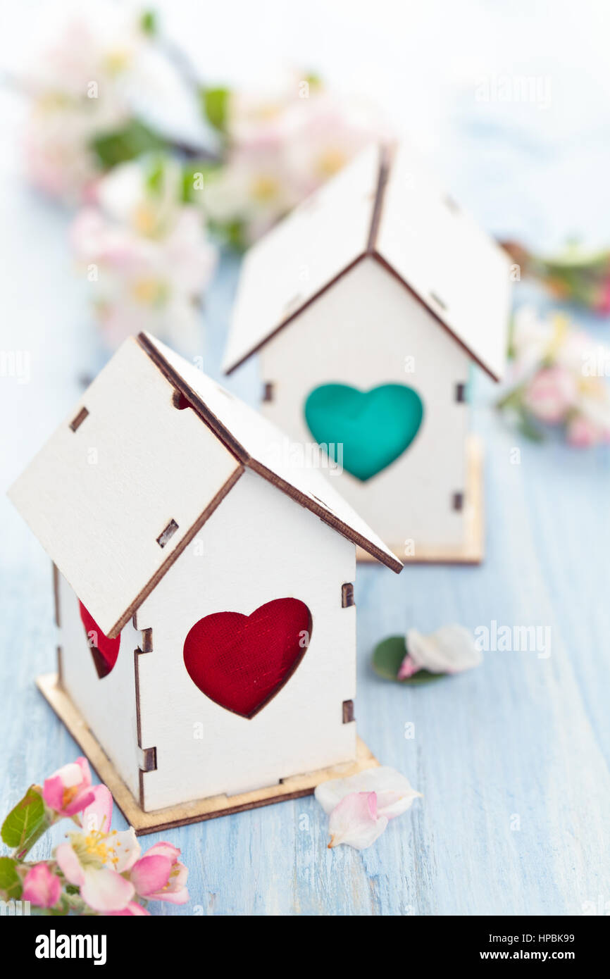 White Wood houses with colorful heart shaped windows Stock Photo - Alamy
